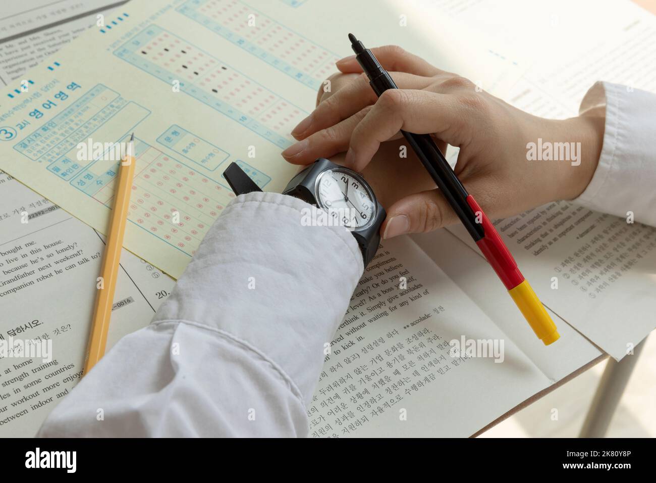 studying at home, study desk setup checking the time and taking the ...