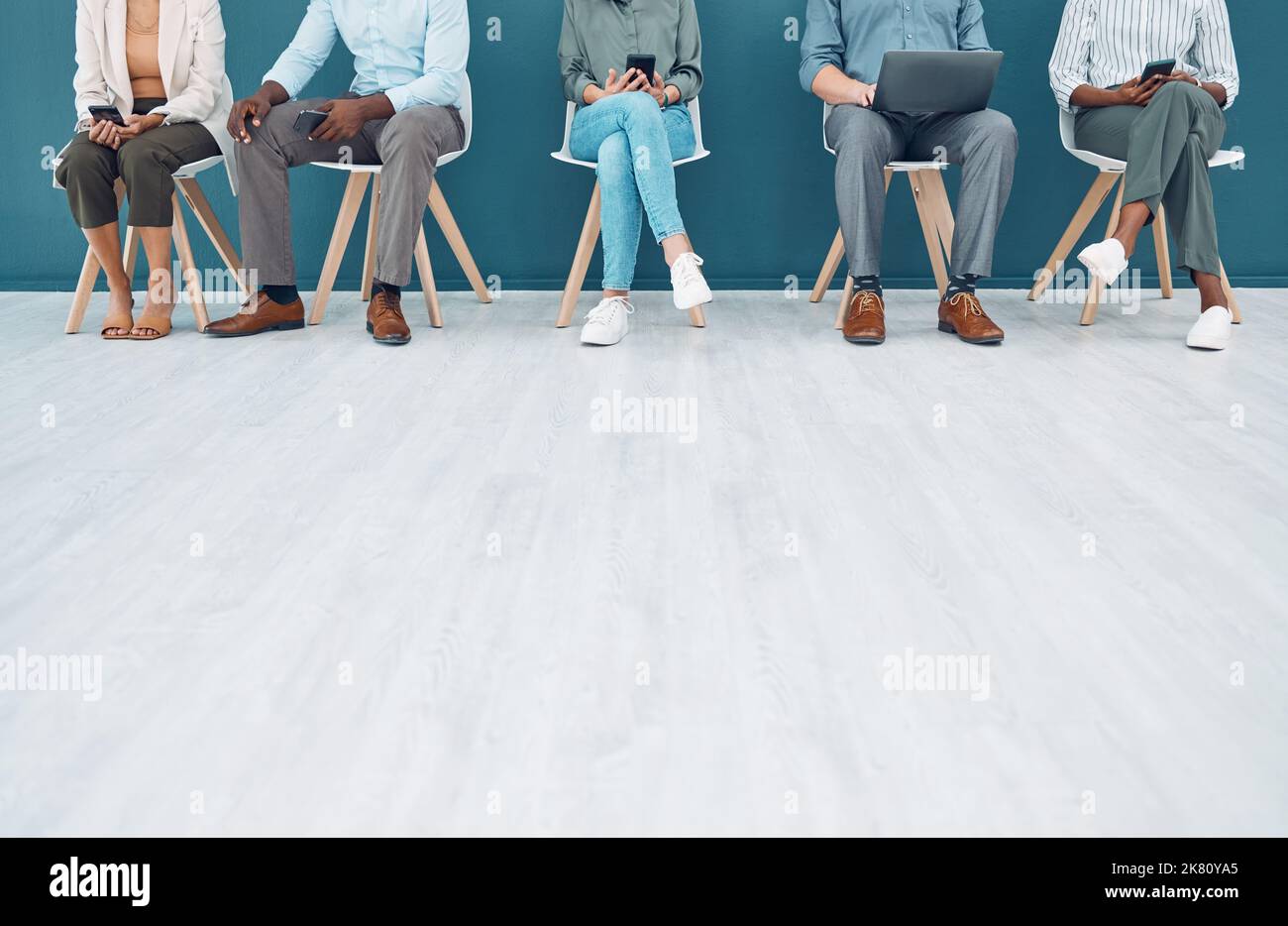 Business people, legs and job interview wait on technology in studio ...