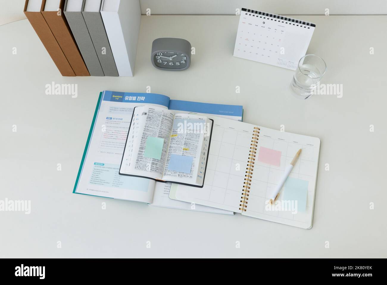 studying at home, study desk setup studying dictionaries and workbooks ...