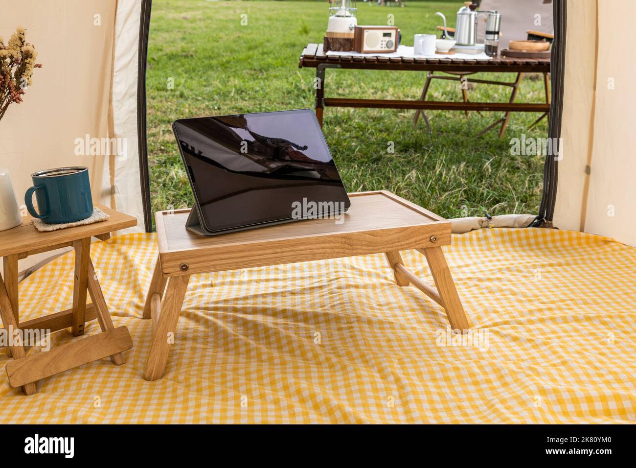 camping mood aesthetics watching tablet pc in a tents Stock Photo - Alamy