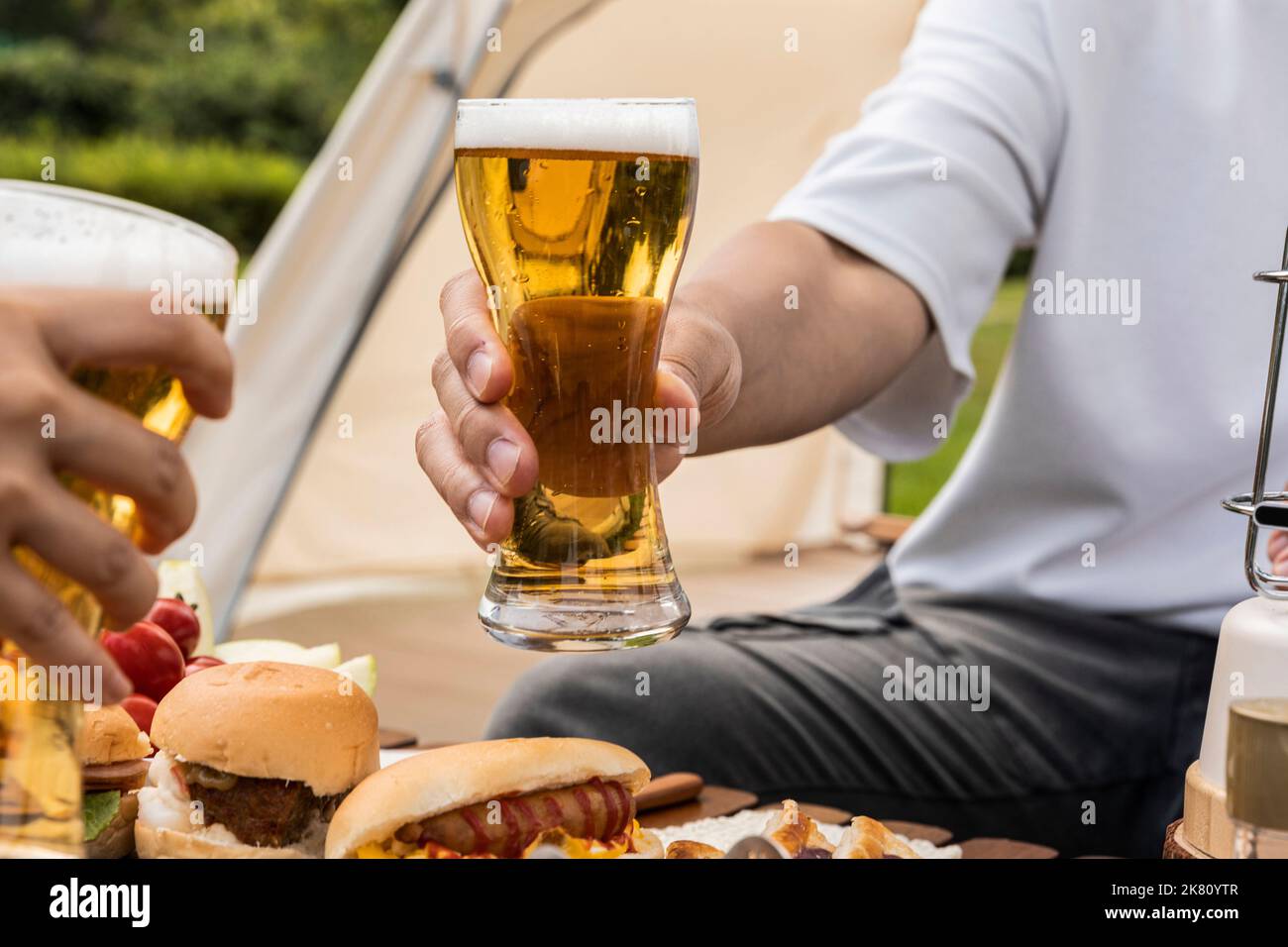 camping mood aesthetics drinking beer Stock Photo - Alamy