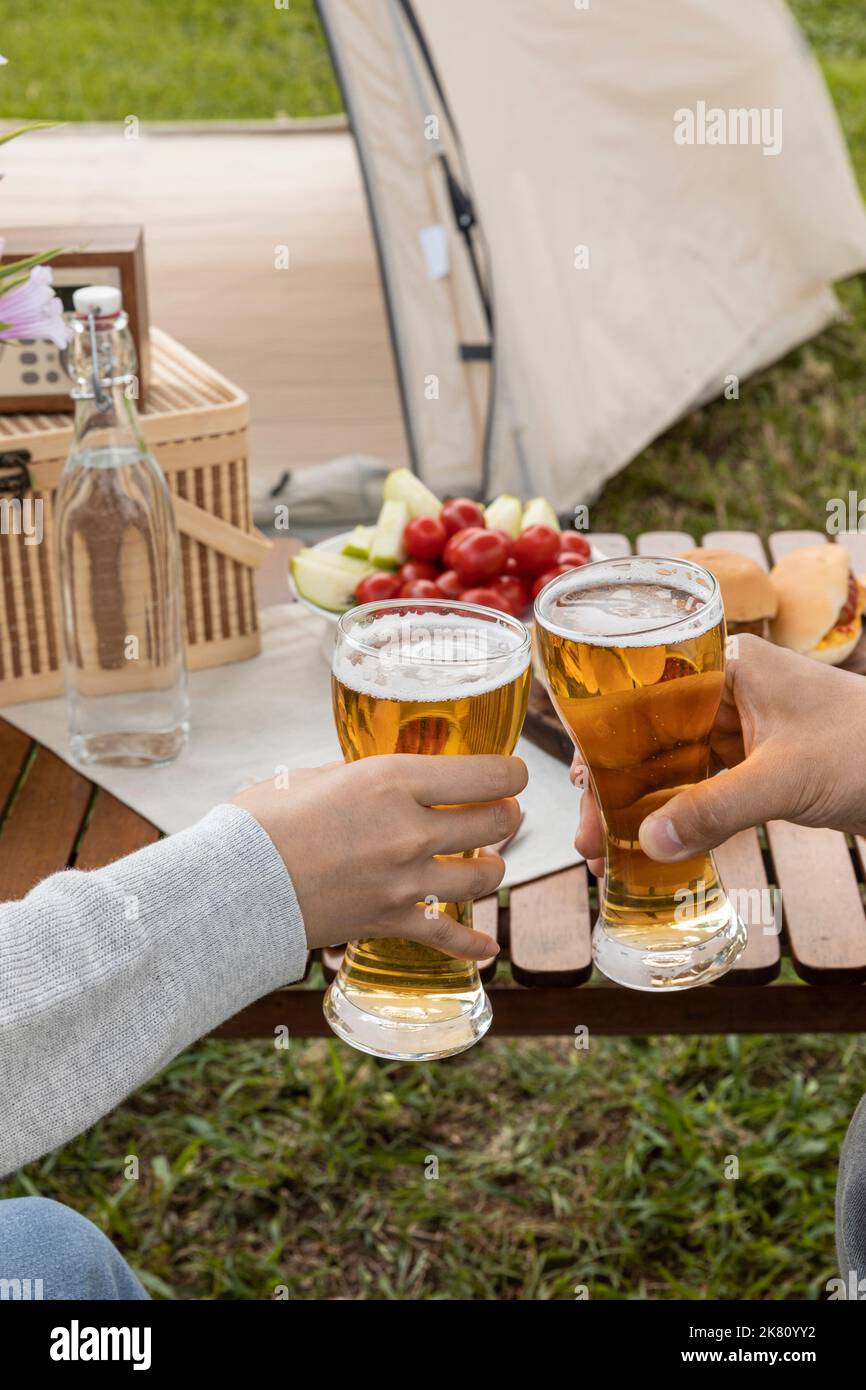 camping mood aesthetics drinking beer Stock Photo - Alamy