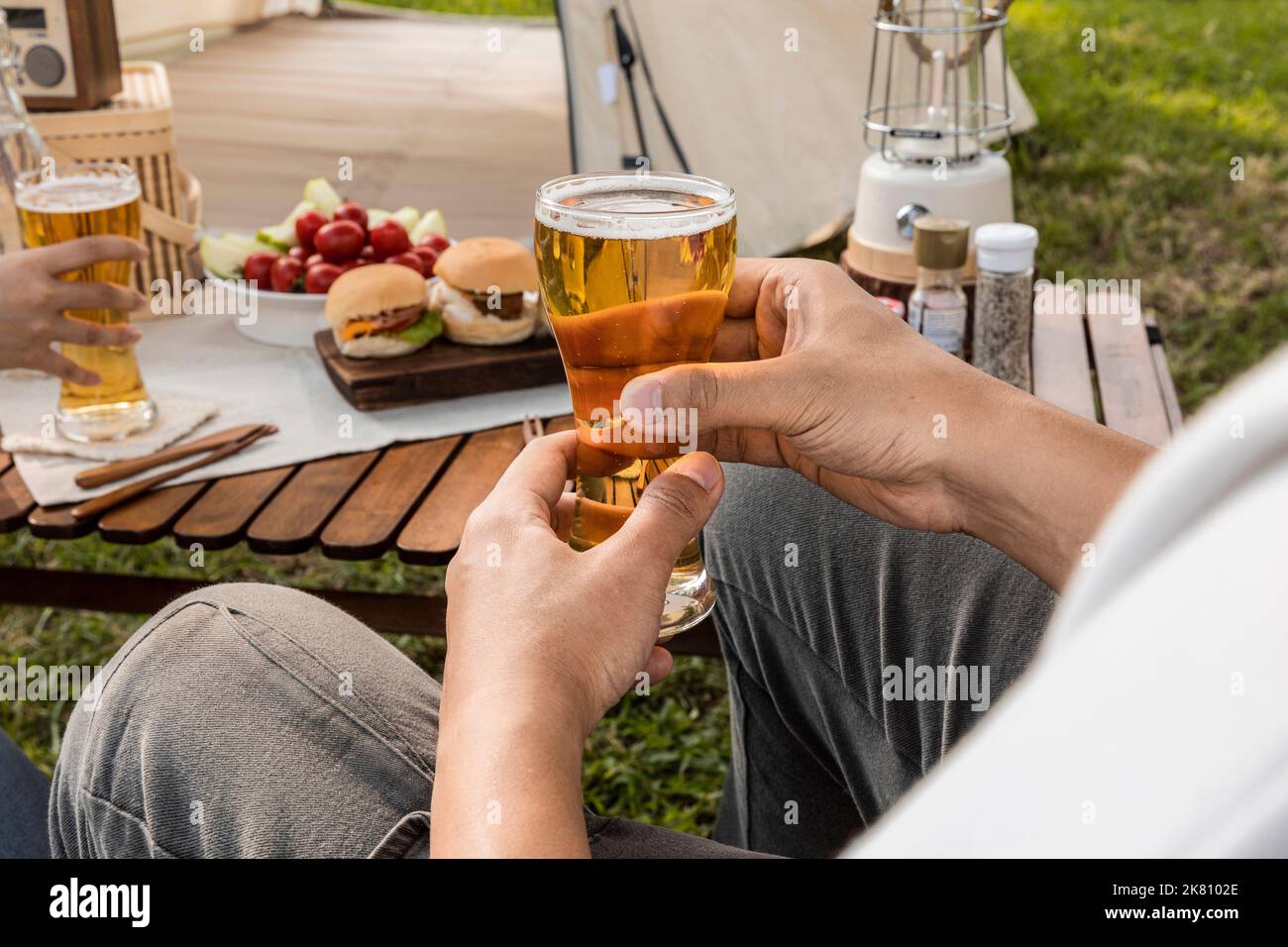 camping mood aesthetics drinking beer Stock Photo - Alamy