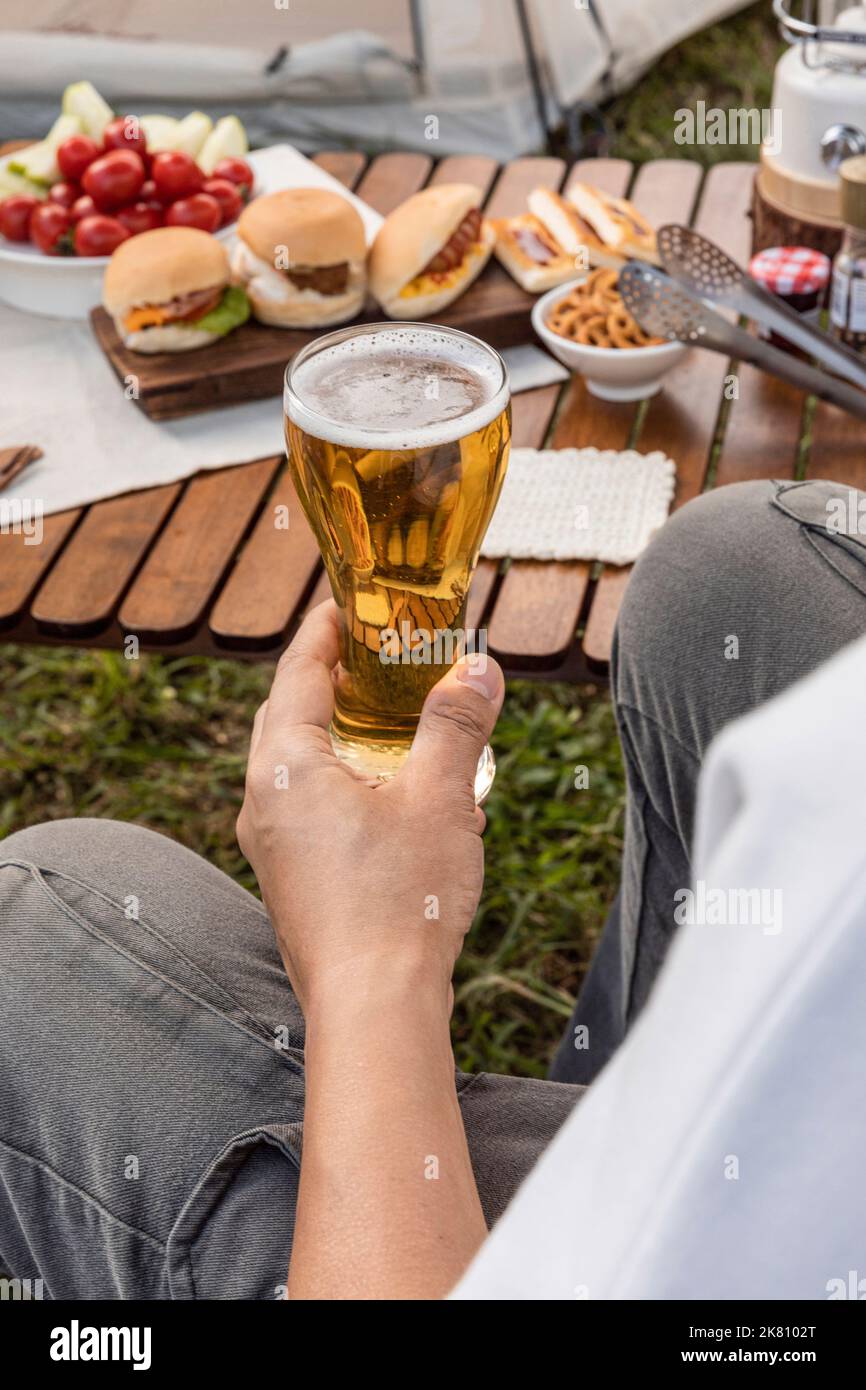camping mood aesthetics drinking beer Stock Photo - Alamy