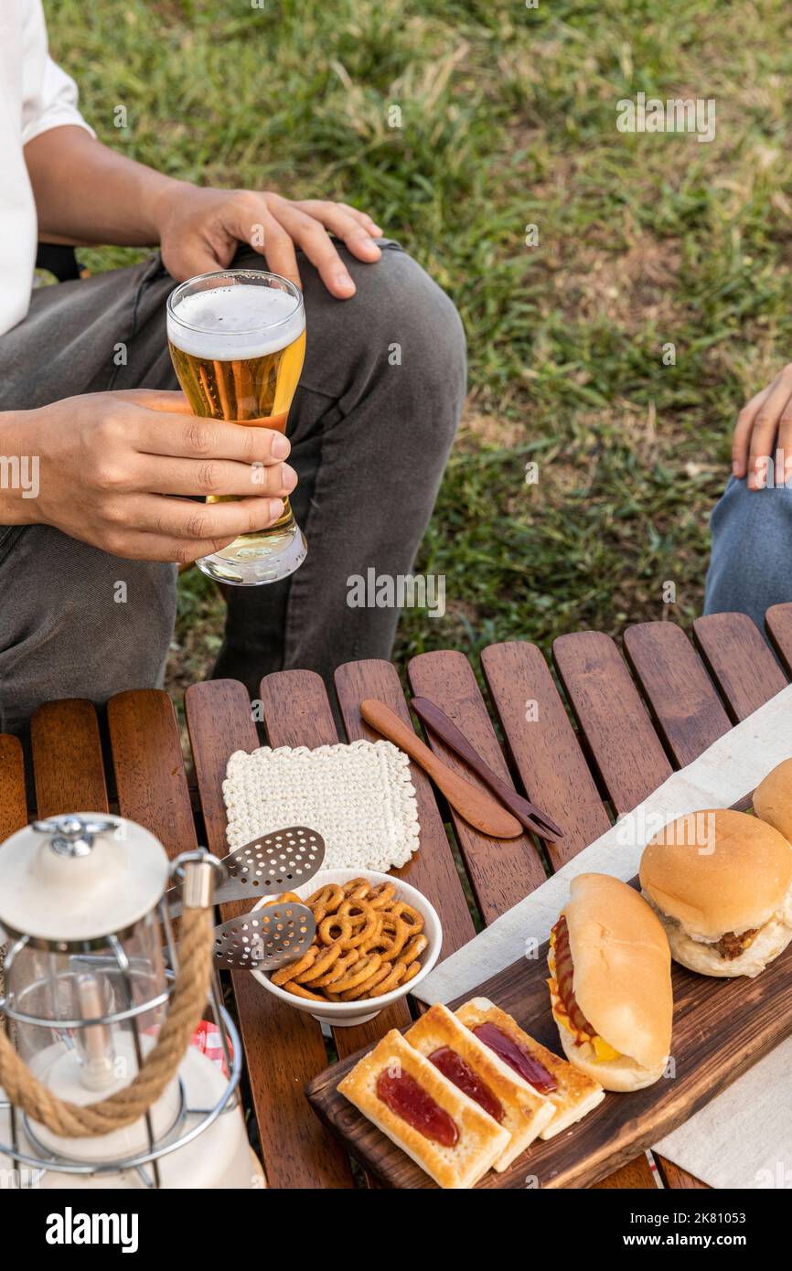 camping mood aesthetics drinking beer Stock Photo - Alamy