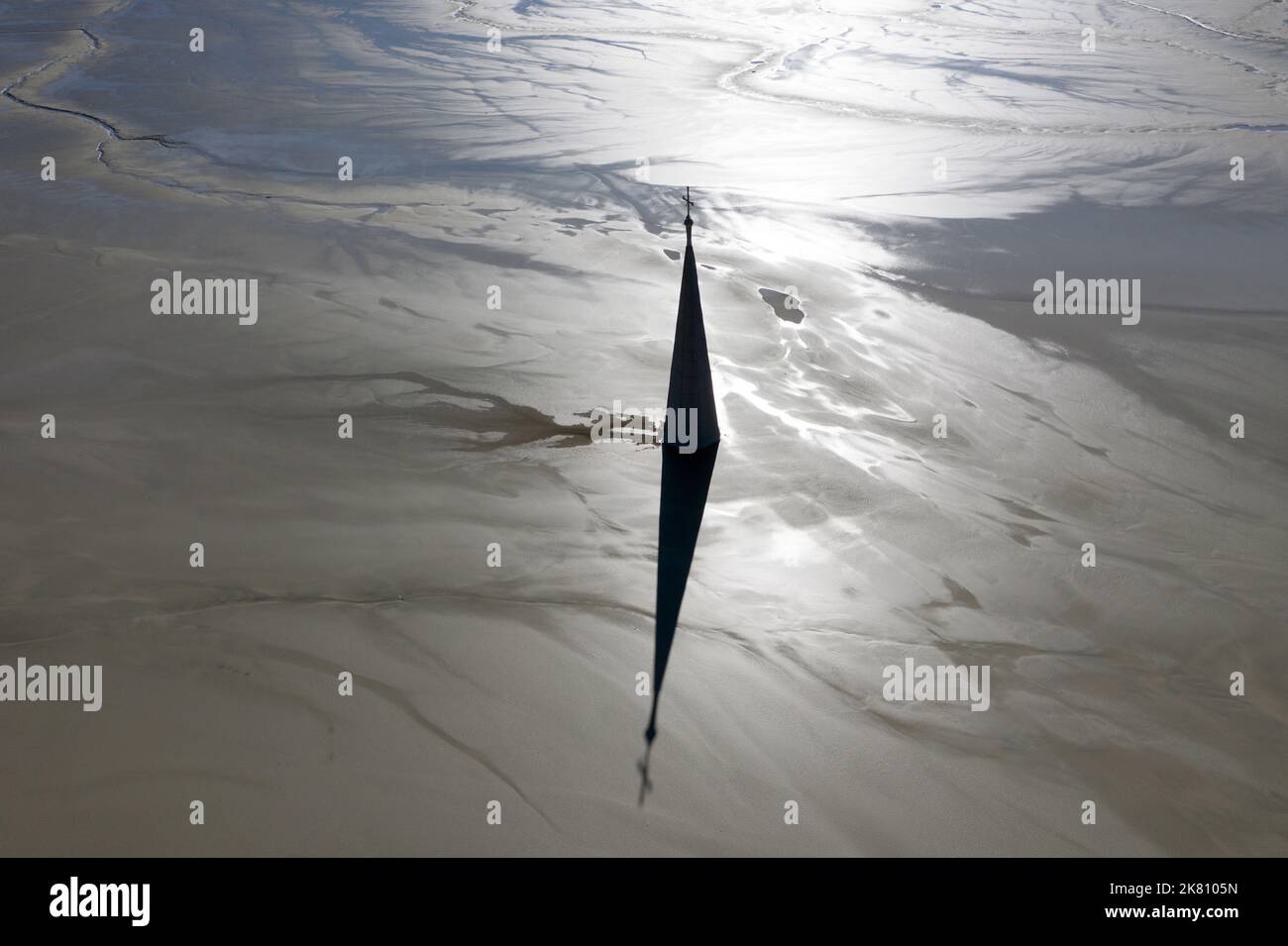 Aerial apocalyptic scene, silhouette of church tower with cross buried ...