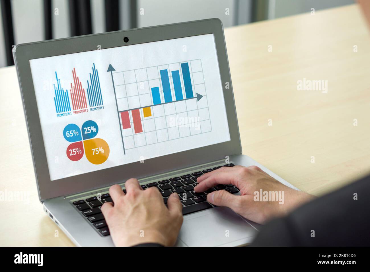 Back view of businessman in suit sit at desk in office typing on laptop ...