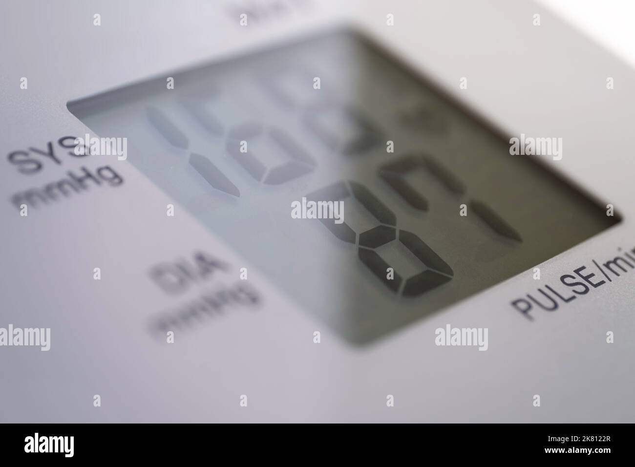 Screen of an electronic digital blood pressure monitor shows the upper ...