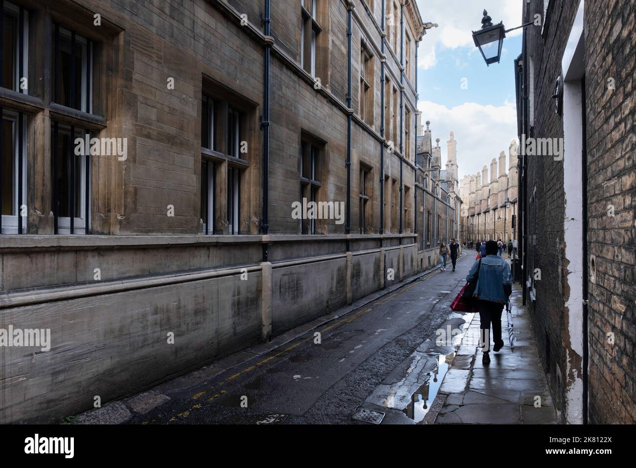 Narrow street with tall classical buildings on a rainy day in the ...