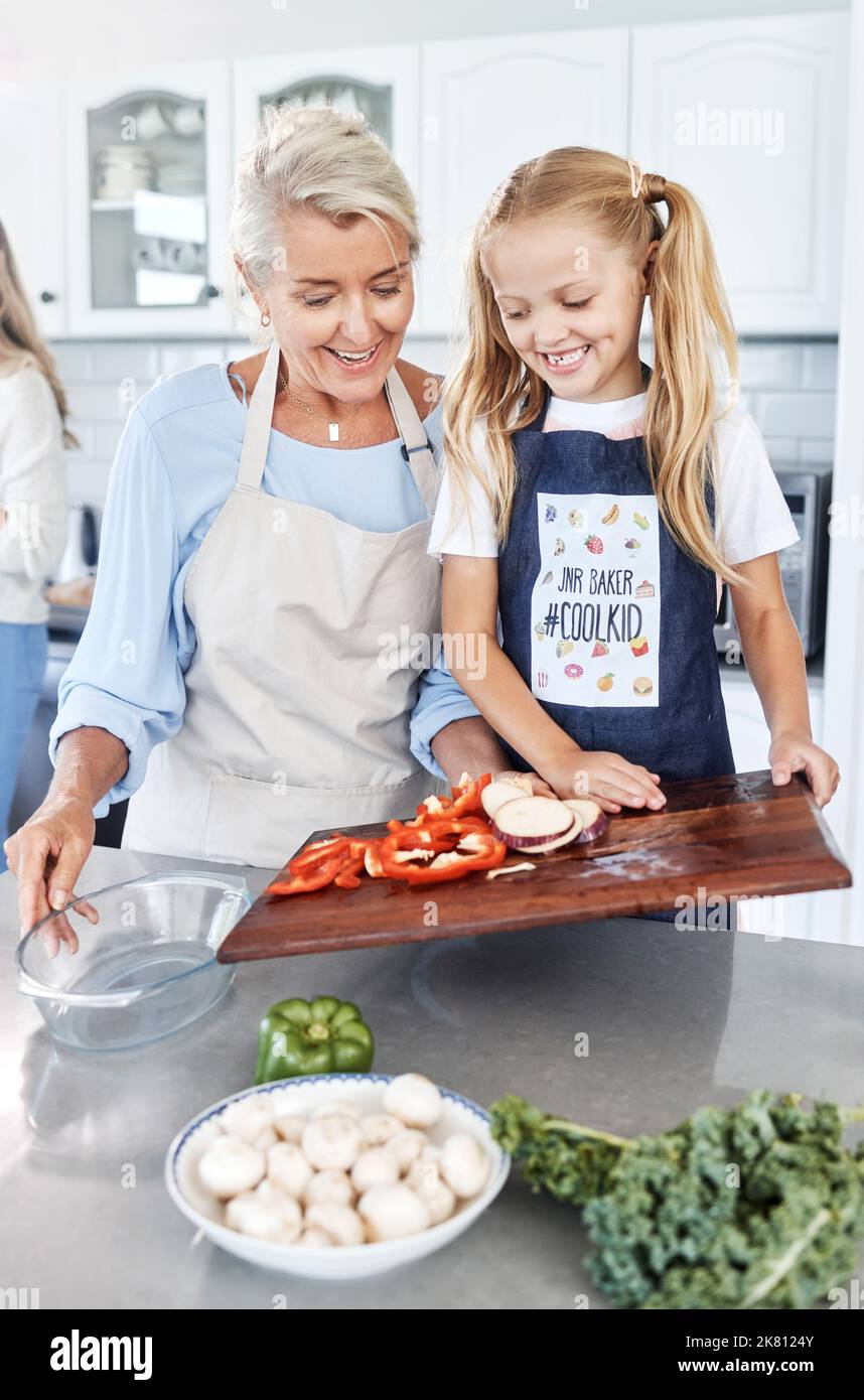 Cooking, child and grandmother teaching a girl our to cook healthy food ...