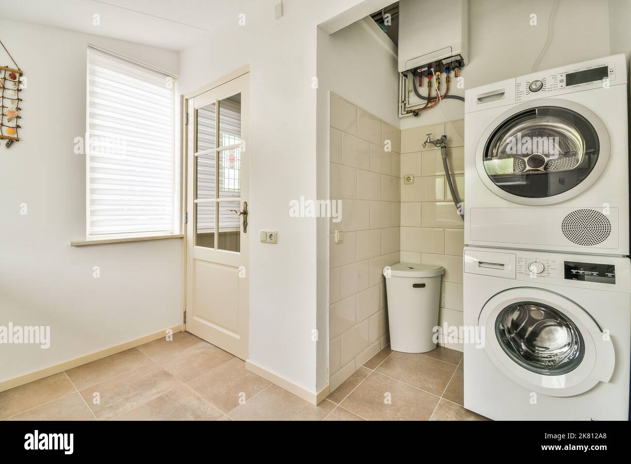 Interior of modern bright laundry room with white walls and dark ...
