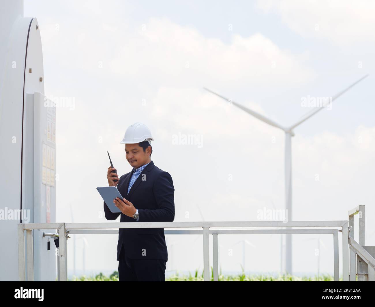 Engineer man manager in a suit is using a tablet to control and monitor ...