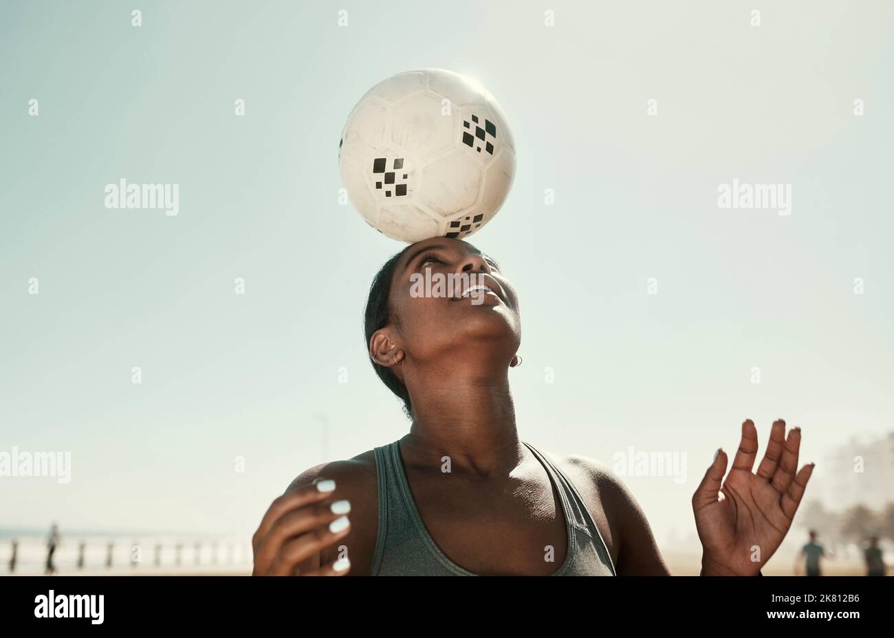 Head balance, sports and soccer ball with woman athlete in the sun and ...