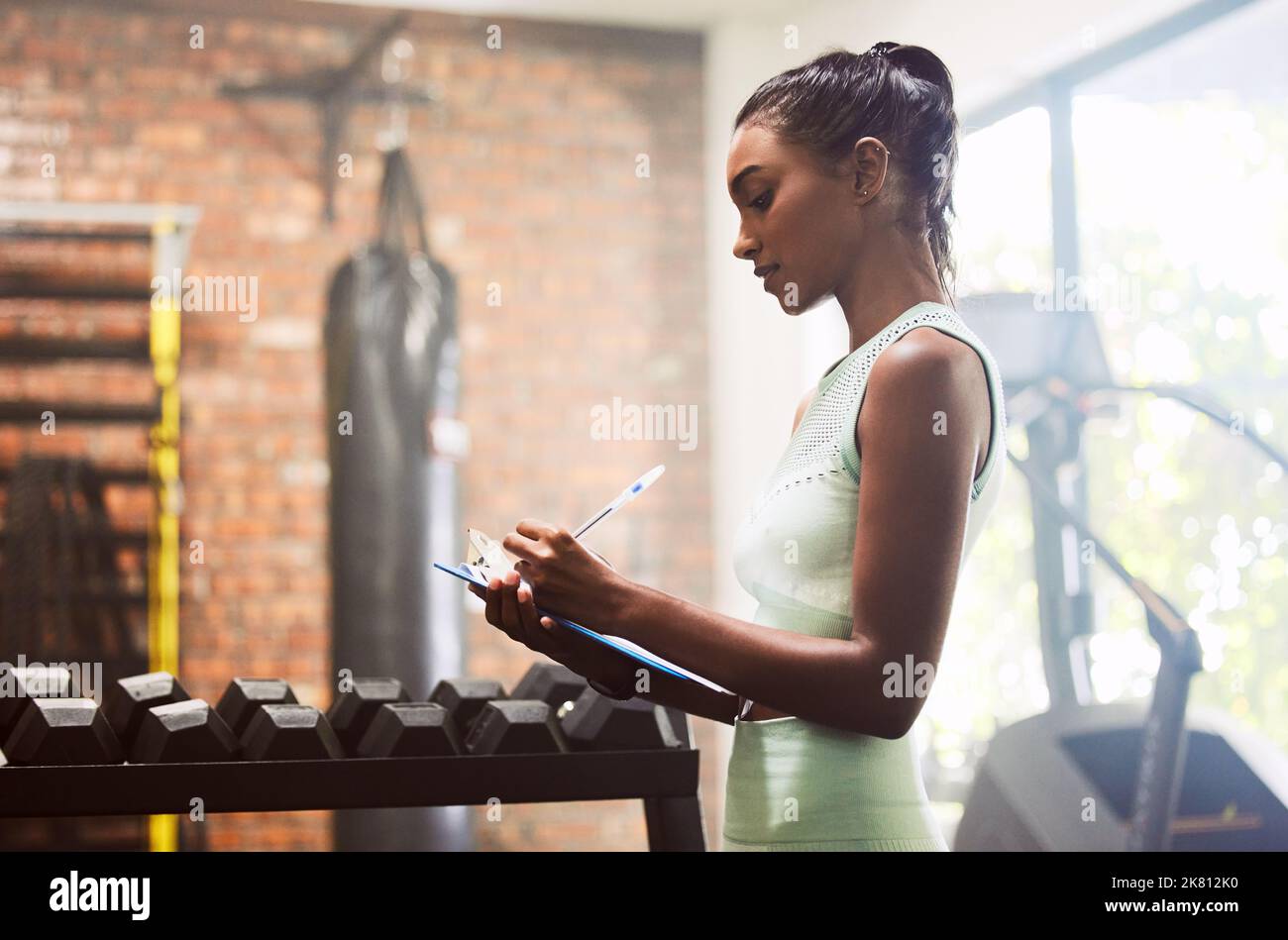 Fully equipped and ready for your fitness needs. a young woman doing ...