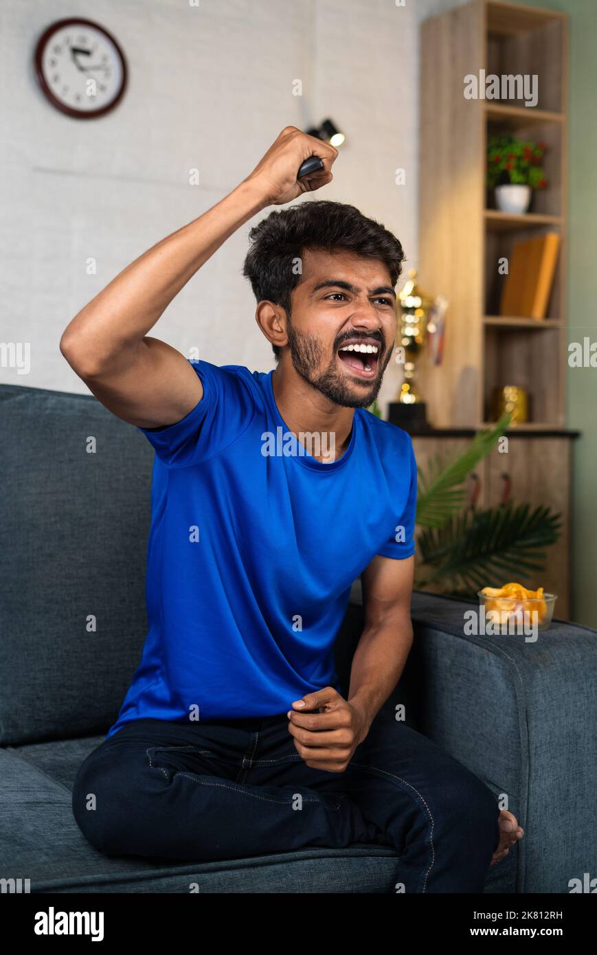 Indian man watching tv smiling hi-res stock photography and images - Alamy