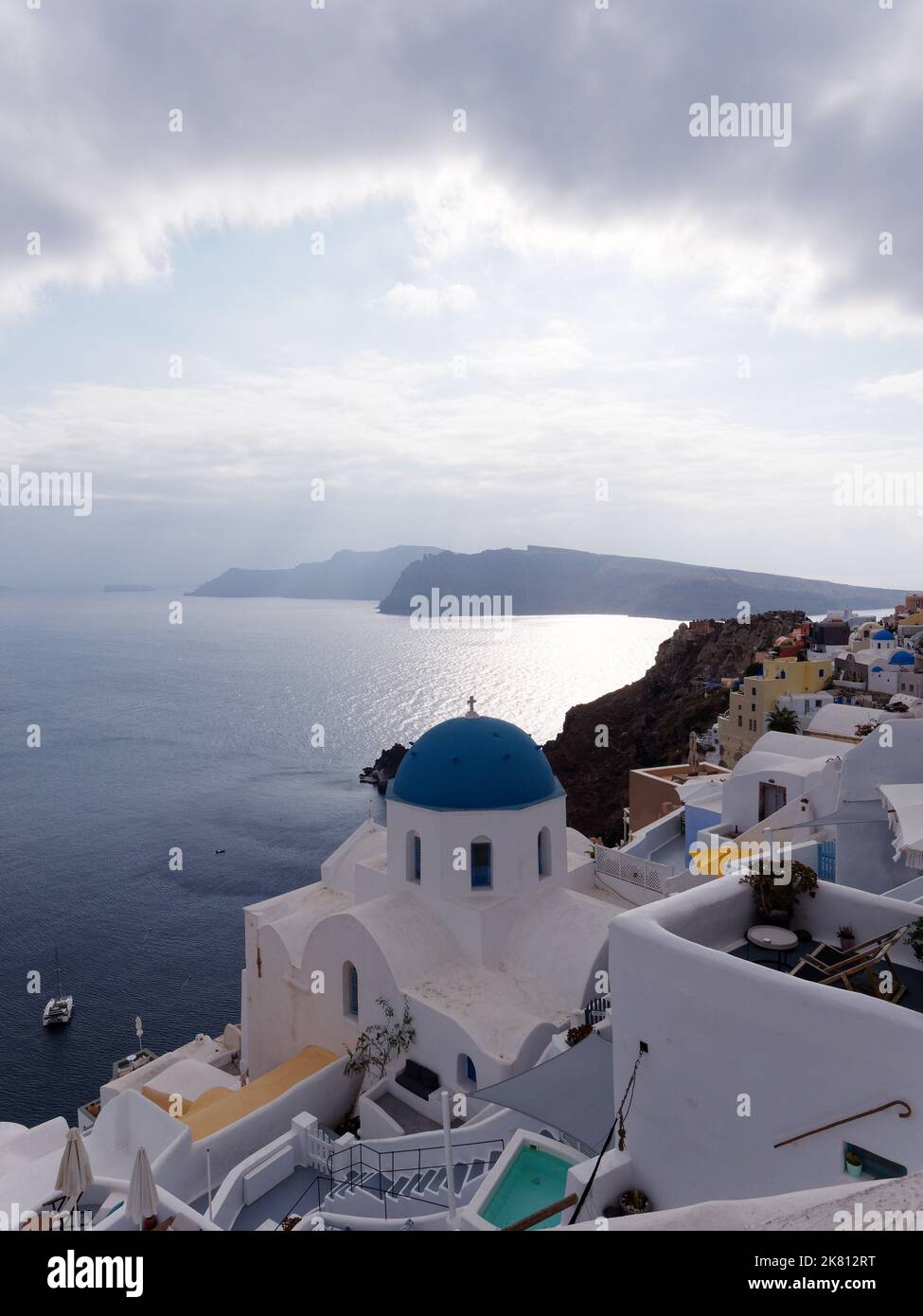 Town of Oia with famous Blue Domed Churches and Caldera view with ...