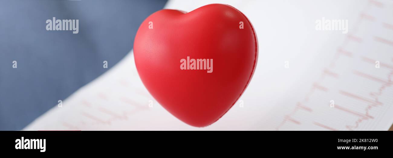 Red plastic heart with electrogram result, professional diagnostic ...