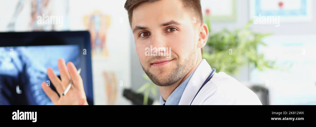 High specialist point on monitor with scan, intelligent man doctor wear ...