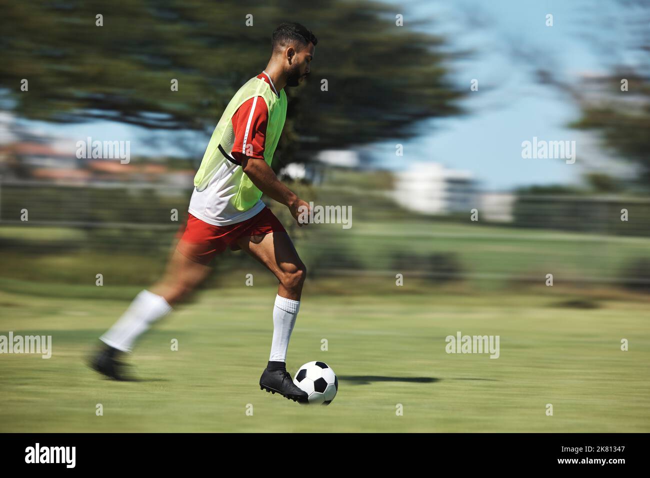 Soccer, sports and man athlete in a football game on sport field ...