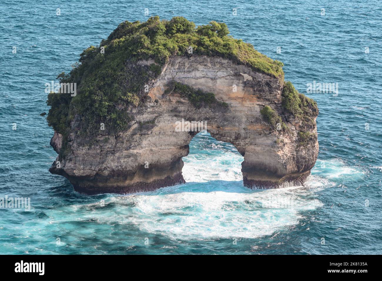 Rocks in arch shapes by the coastline of Nusa Penida island. Viewpoint ...