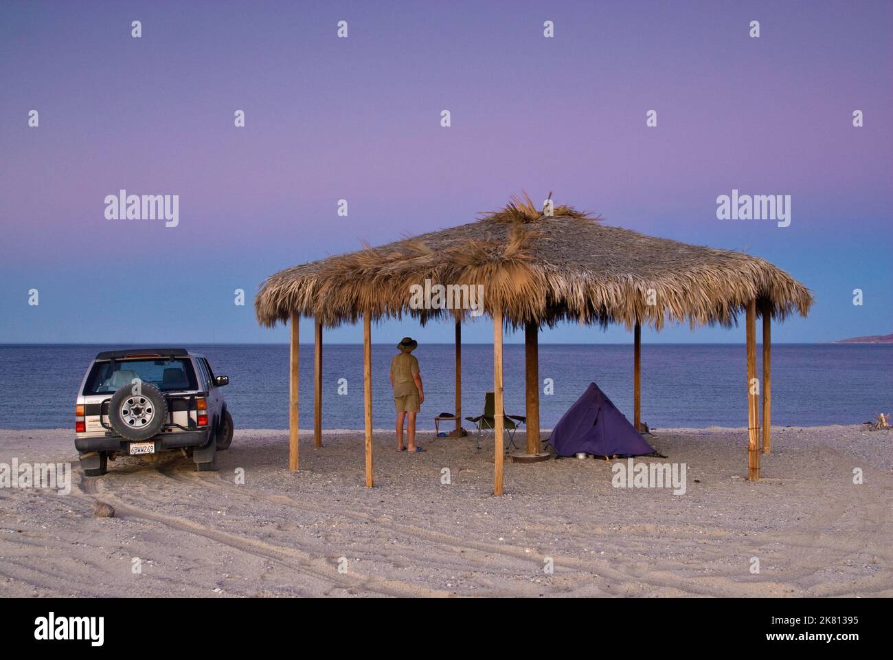 Camper at palapa on beach after sunset at Bahia San Luis Gonzaga at ...