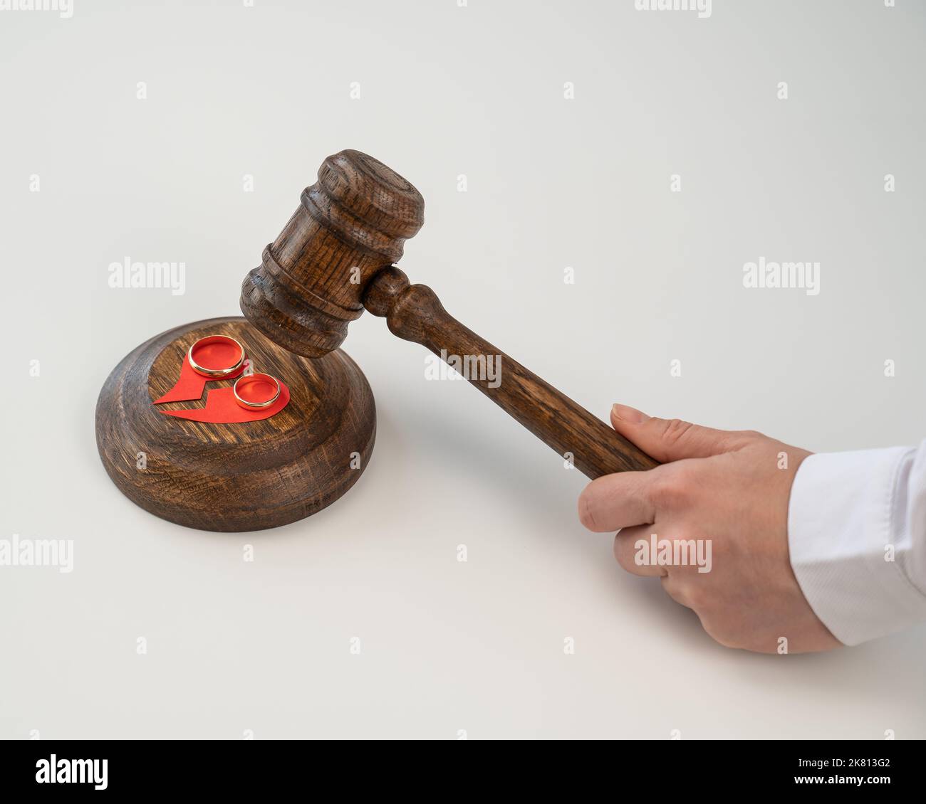 The judge hits the gavel on a broken heart and wedding rings Stock ...