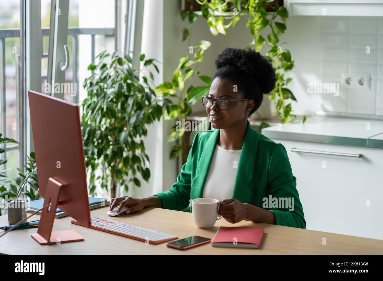 Young African American woman secretary working sits at office desk with ...
