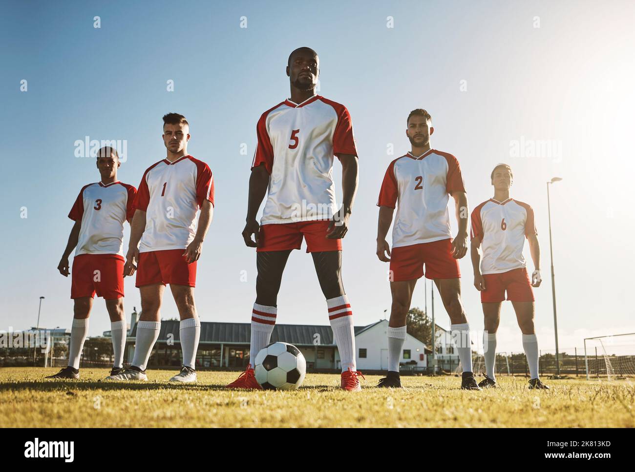 Soccer player, team and sports training on soccer field by men standing ...