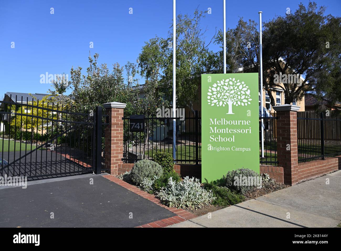 Green Melbourne Montessori School sign, featuring tree logo, outside ...