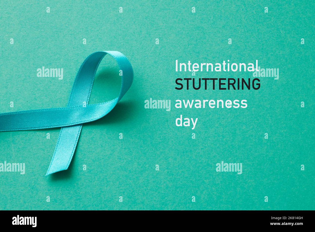 the text international stuttering awareness day and an aquamarine ...