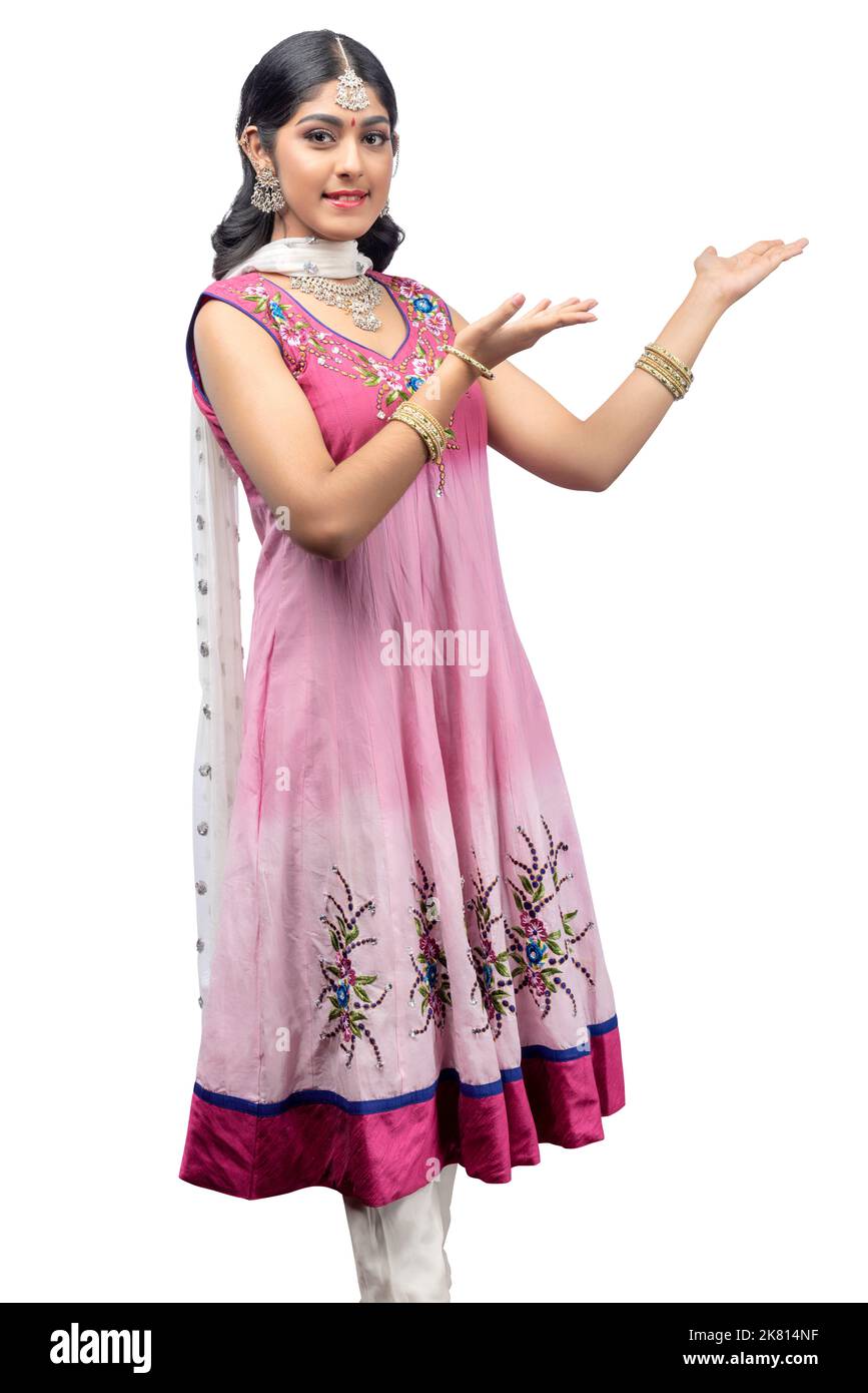 Indian woman in traditional Anarkali dress standing with an open palm ...
