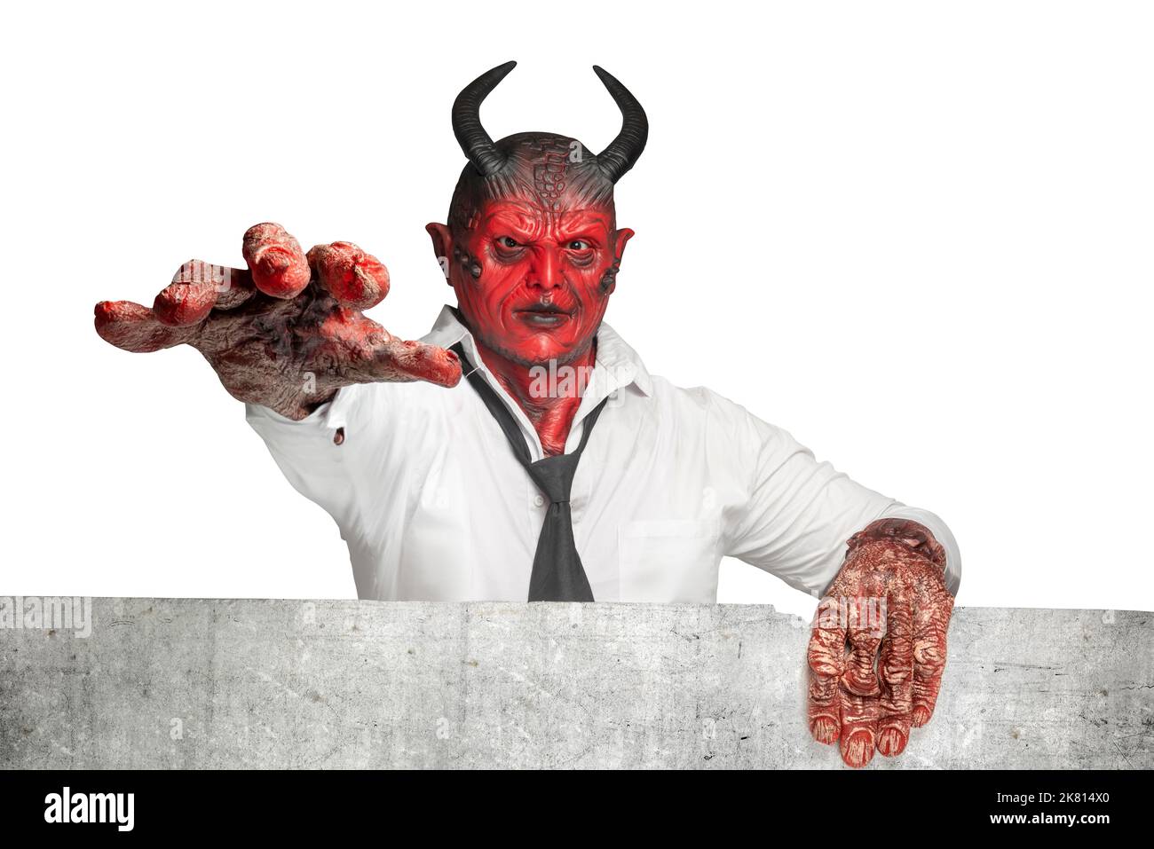 Devilman standing behind the wall isolated over white background ...