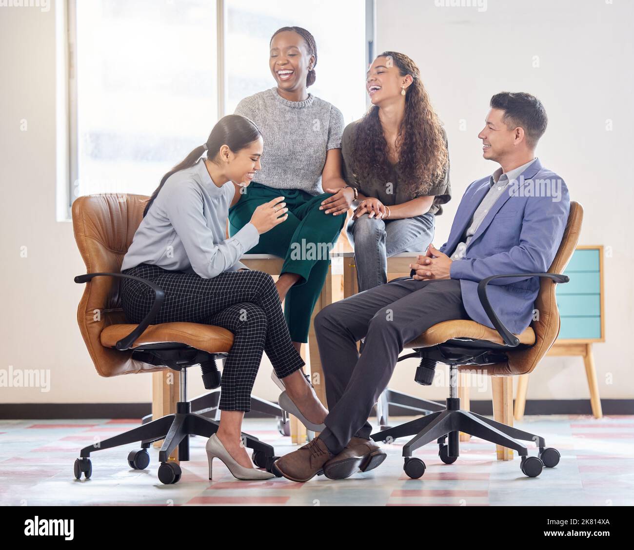 Laughter makes for a good day. a group of colleagues in an office at ...