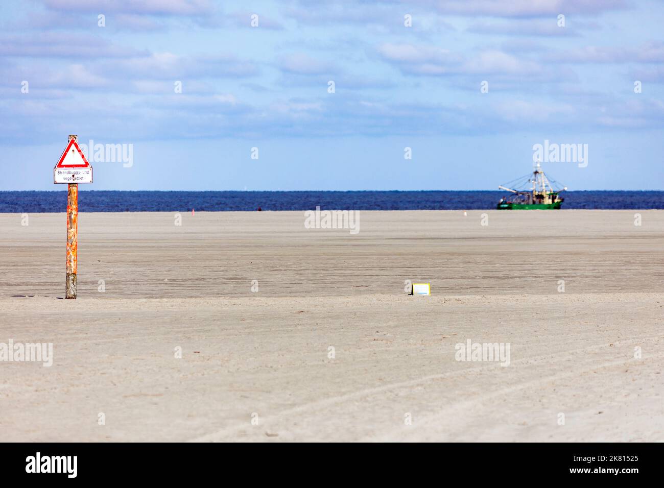 Shrimp boat on the North Sea coast and sandy beach at low tide in Sankt ...