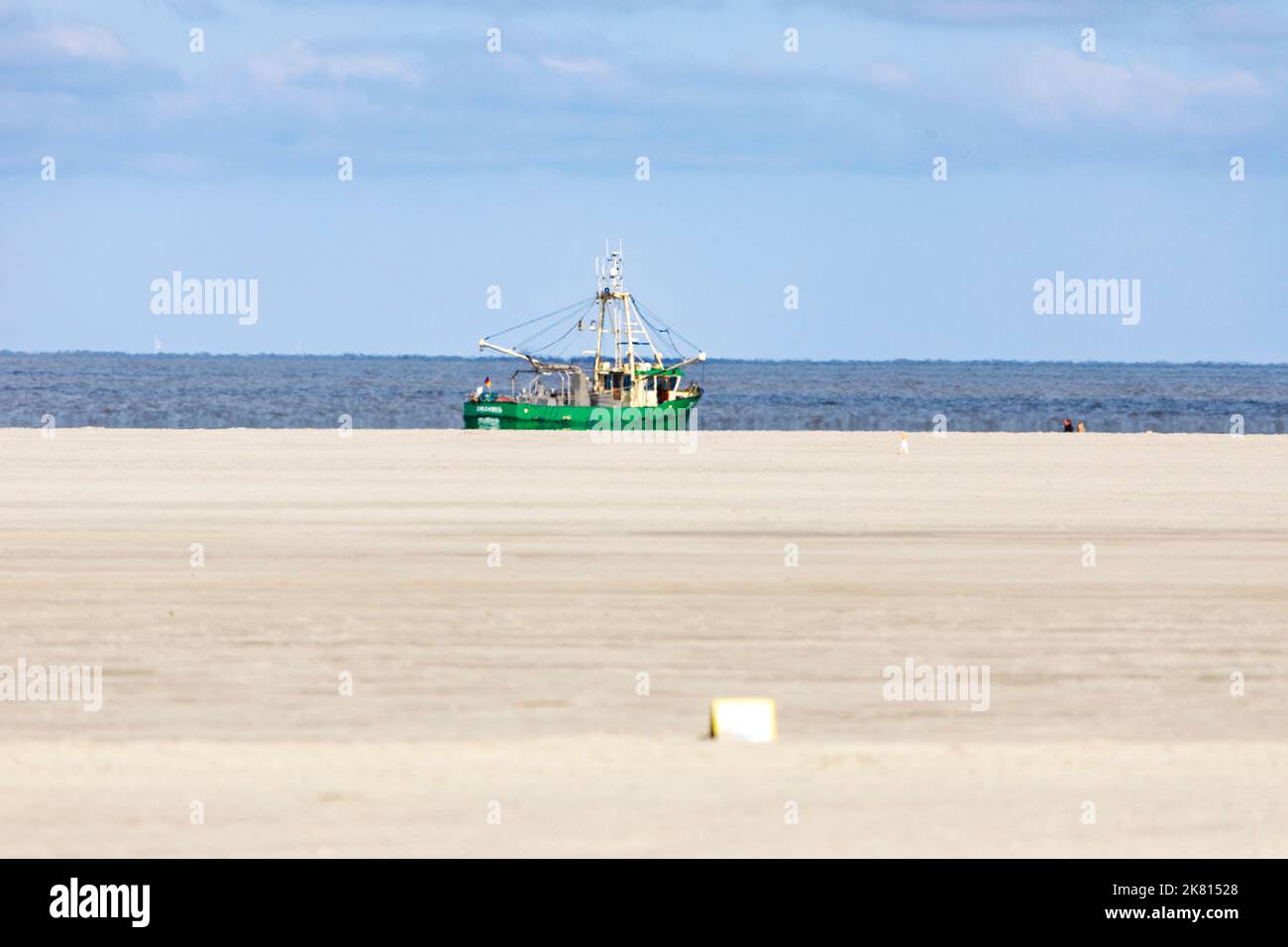 Shrimp boat on the North Sea coast and sandy beach at low tide in Sankt ...