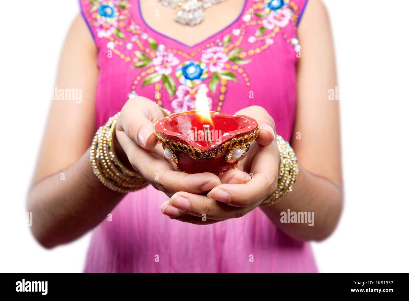 Woman hand holding Diya oil lamps for the Diwali festival isolated over ...
