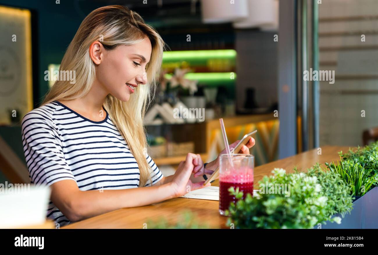 Portrait of happy woman smiling and using mobile phone. People ...