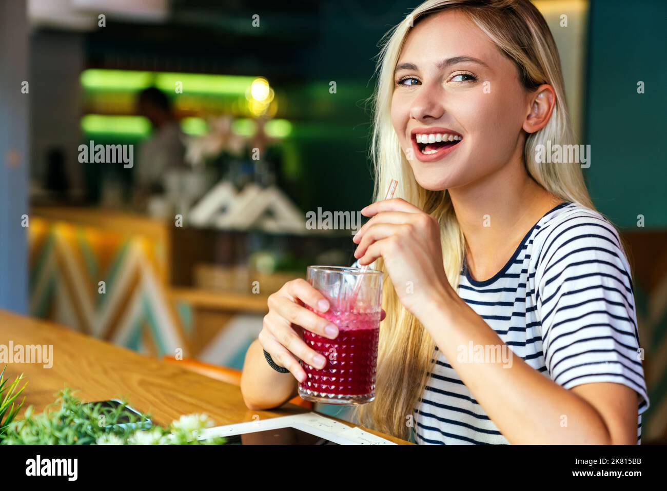 Young woman having a good morning healthy smoothie drink made of super ...