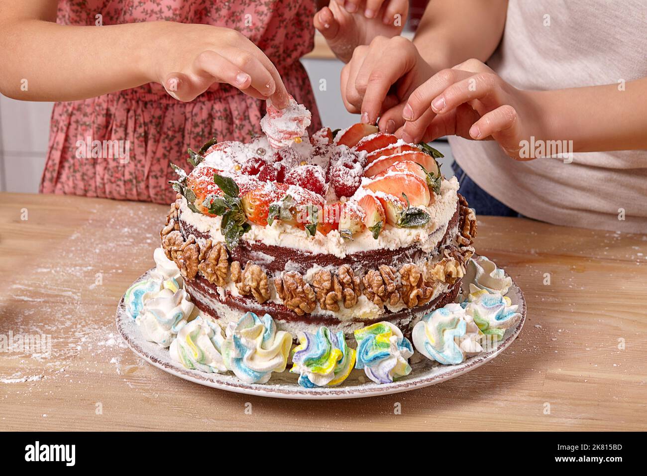 Little friends are making a cake together at a kitchen Stock Photo - Alamy