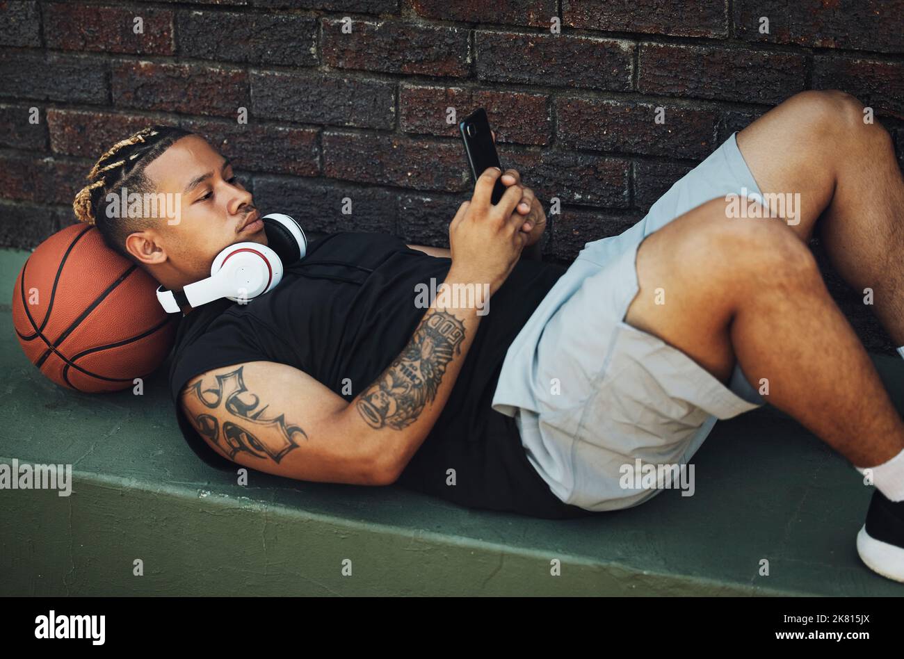 Man relax, basketball and phone with sports app, communication and ...