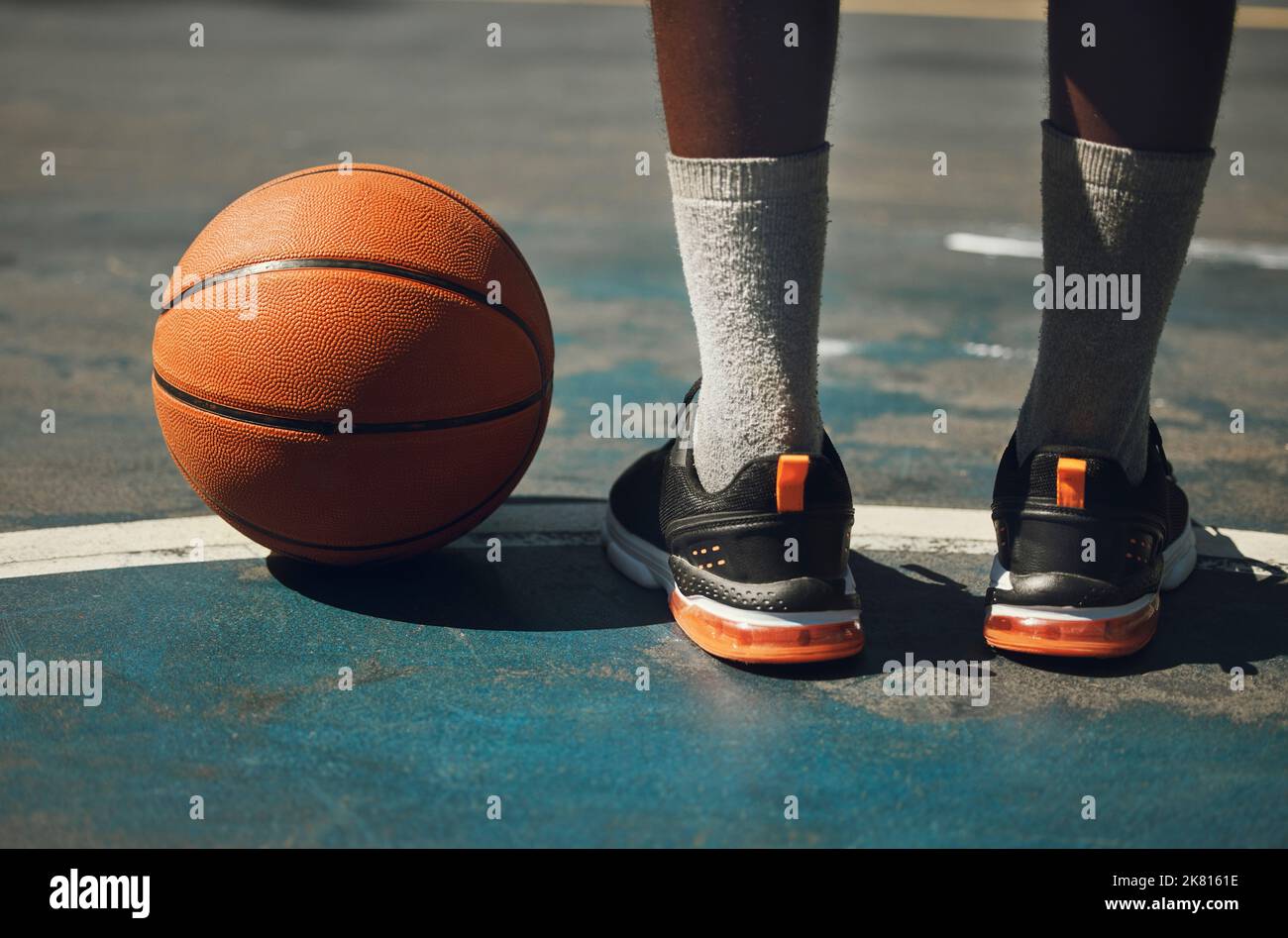 Basketball, basketball player and athlete legs close up on basketball ...