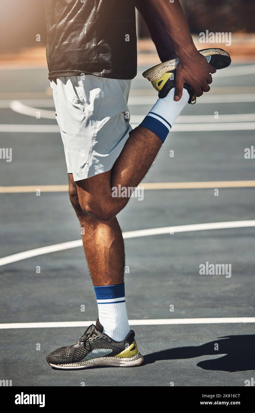 Basketball court, man and stretching legs outdoor for exercise, muscle ...
