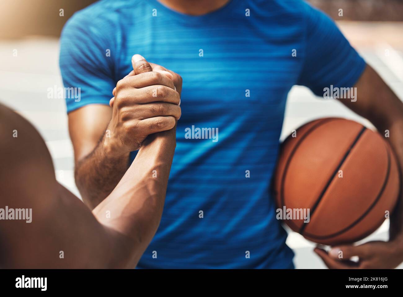 Basketball players, handshake and greeting with ball to celebrate for ...