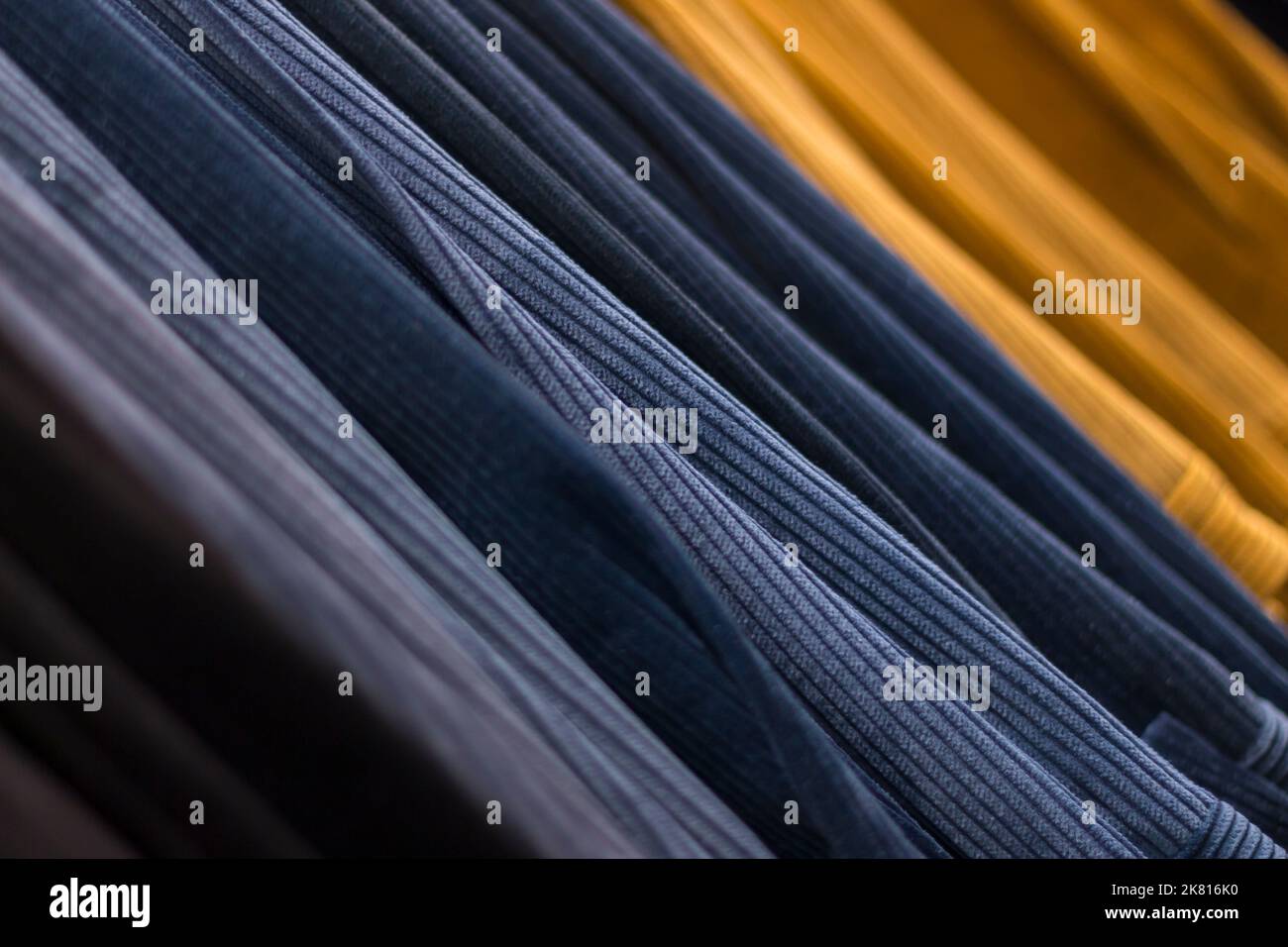 Close up on textile pattern background selection for men trousers, no ...