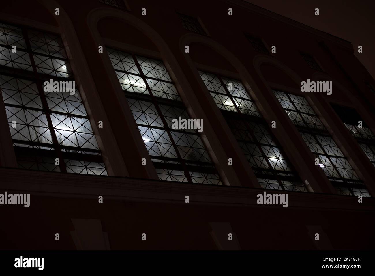 Windows at night. Light in windows in evening. Building outside in dark ...