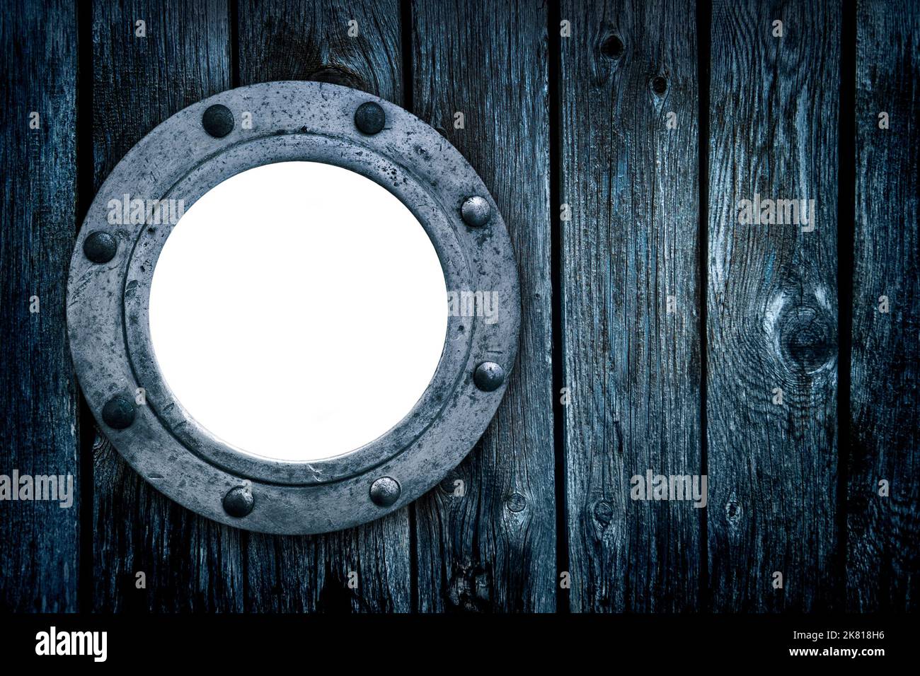 Close-up of an old rusty closed empty porthole window. Old blue rich ...