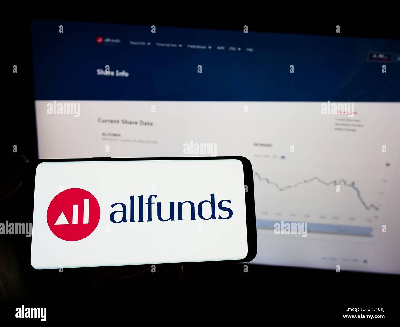 Person holding mobile phone with logo of Spanish financial company ...