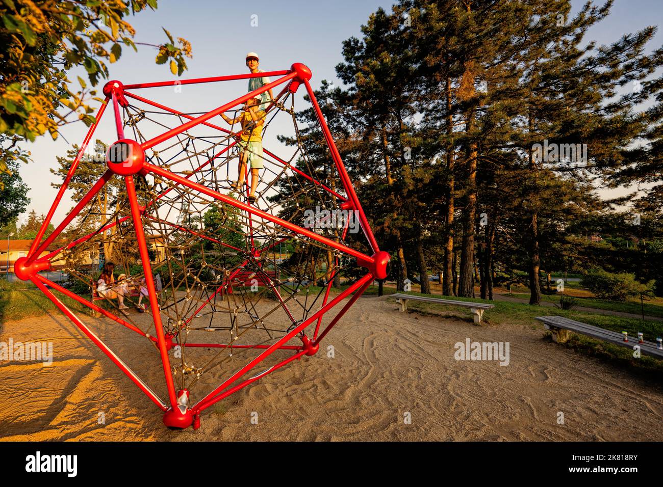 Brothers play in rope polyhedron climb at playground outdoor Stock ...