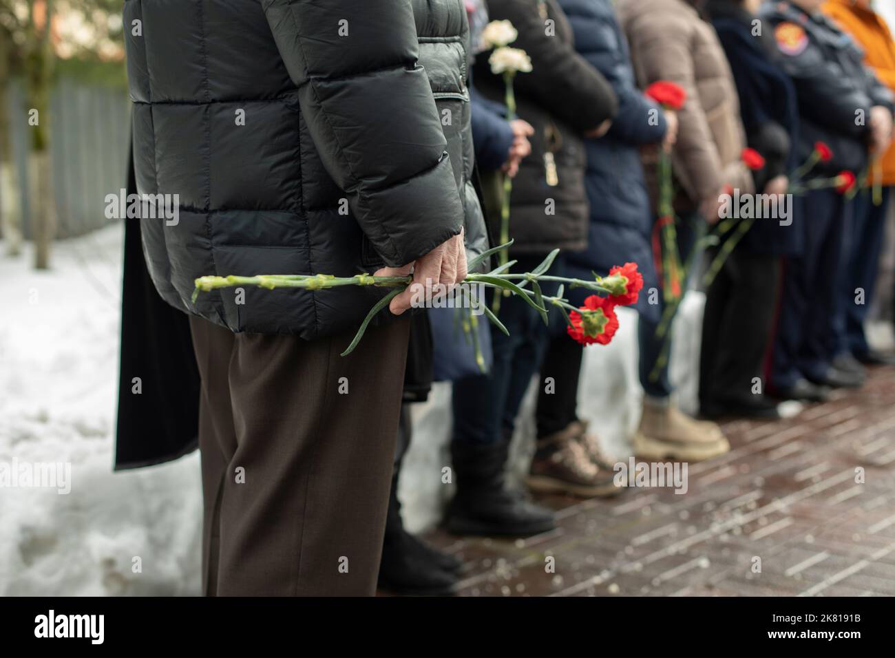 Flowers in old man's hand at funeral. Details of funeral ceremony ...