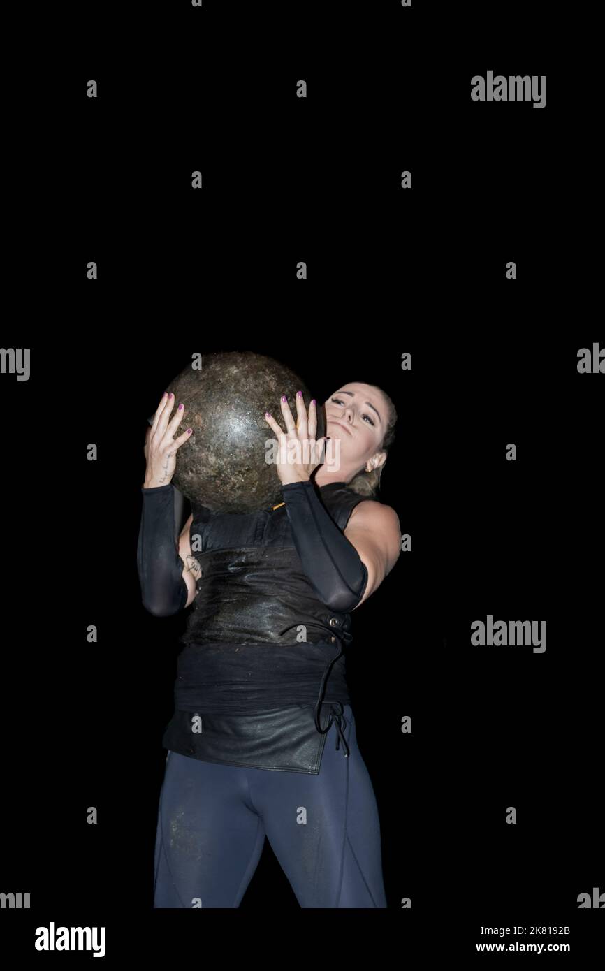 Basque stone that elevates the concept of rural sport. woman from the ...